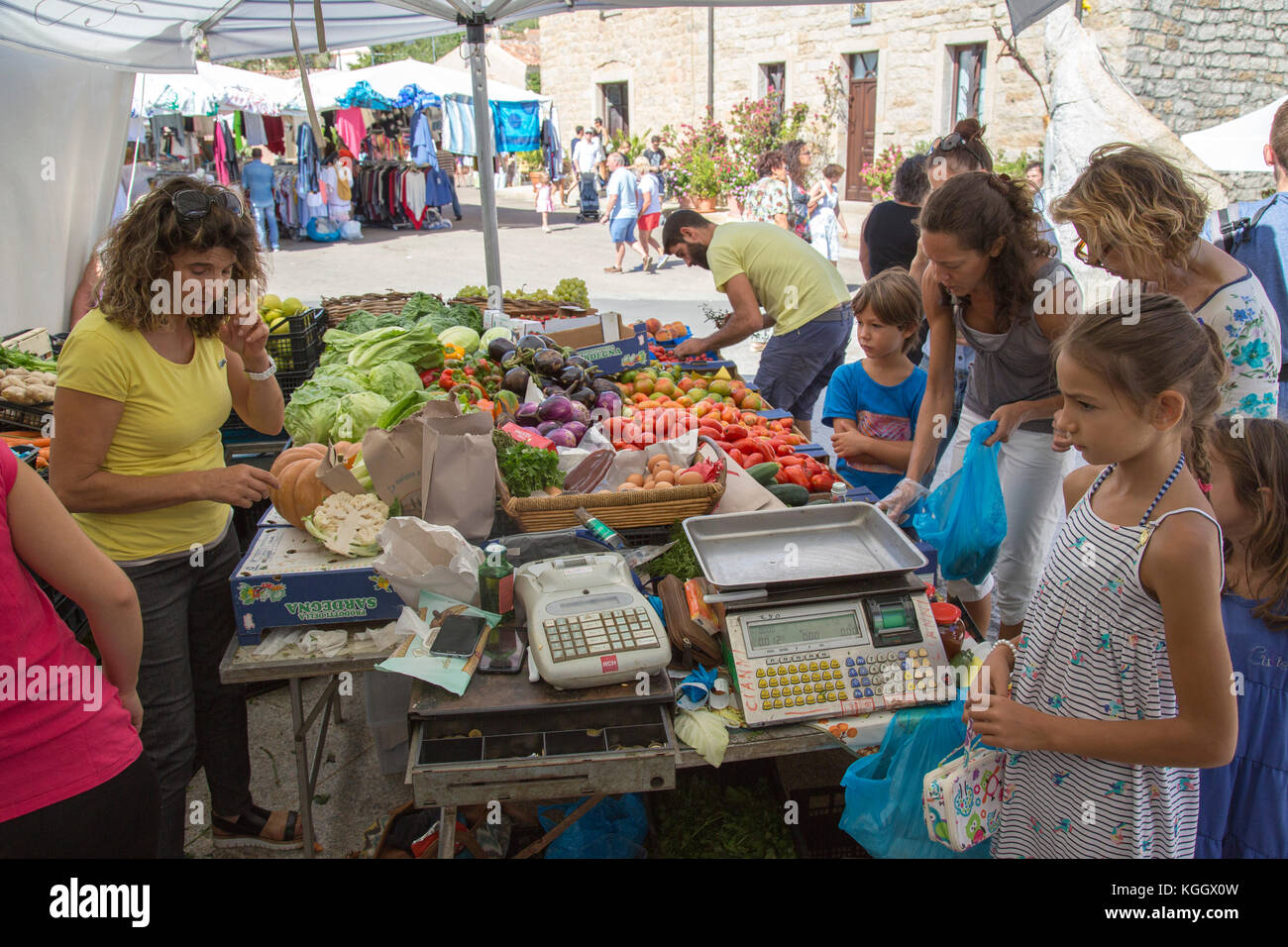 Farmers selling fresh vegetables and fruit in a traditional open-air ...