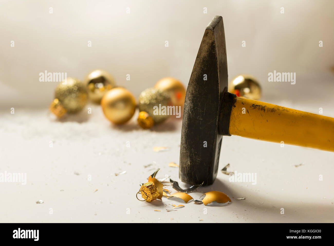 Shattered Christmas ball with hammer - anti christmas Stock Photo - Alamy