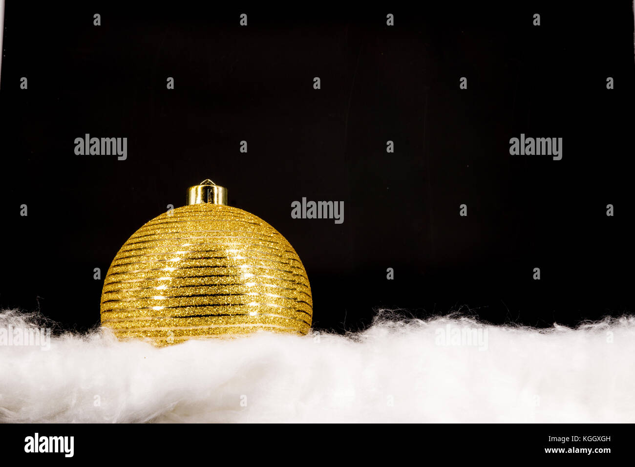 Gold christmas balls with snow isolated on black background Stock Photo ...