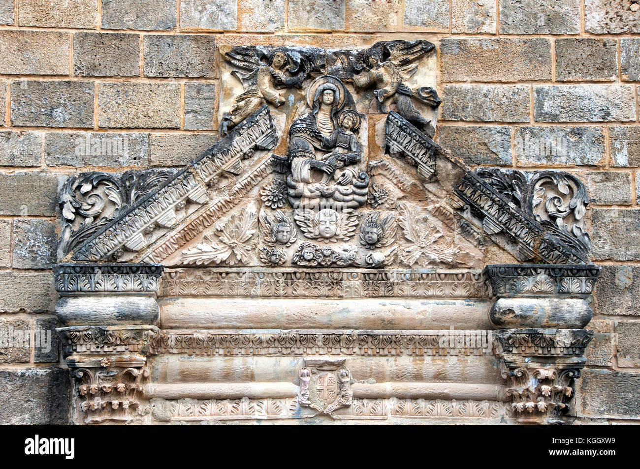 close up of a stone frame sculpture at the entrance of an old church ...