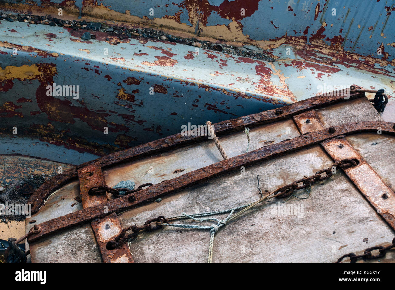 Close up photograph of the rust and worn, peeling paint on two old ...