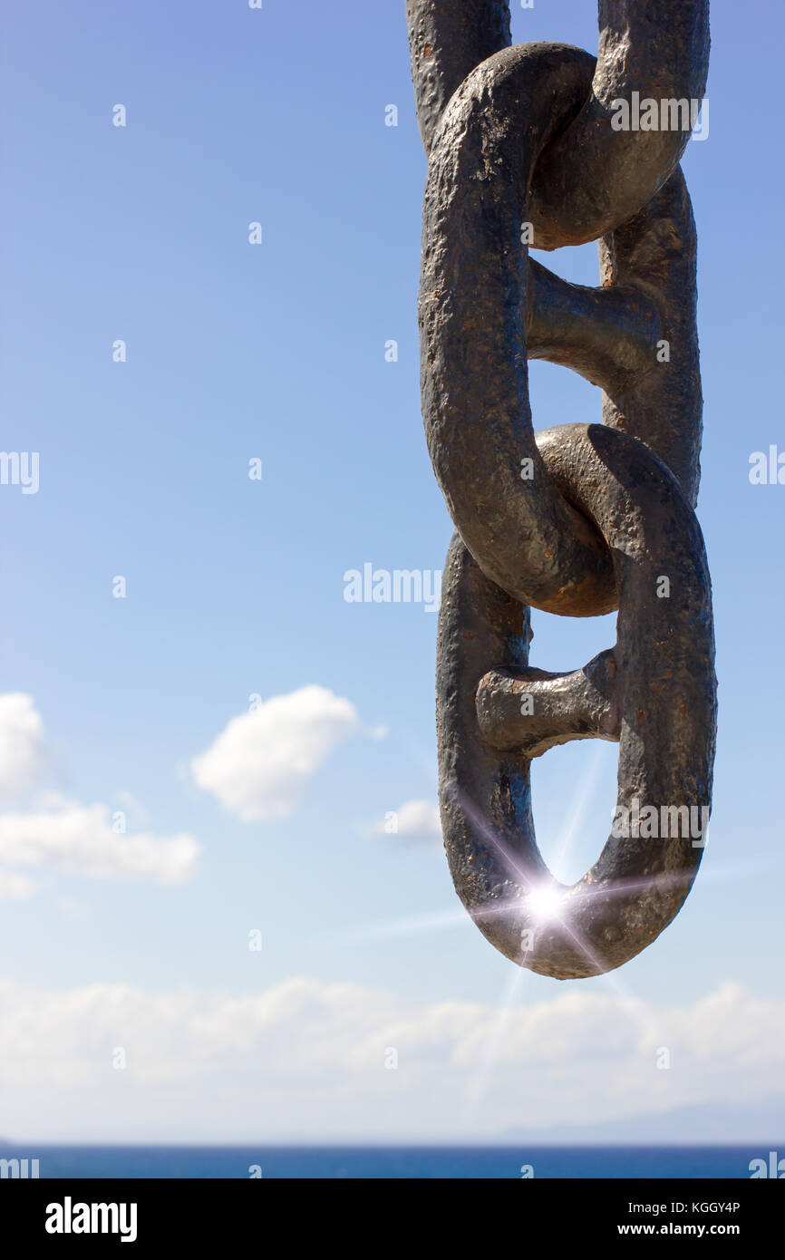 big chain with sun flair and sea with sky in the background Stock Photo ...