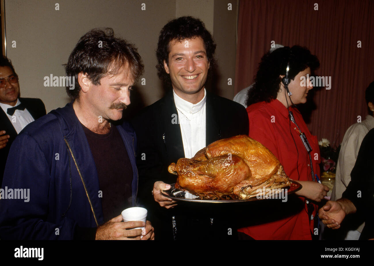 Robin Williams and Howie Mandel holding a cooked turkey backstage at ...