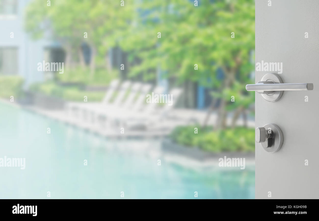 opened white door to swimming pool with beach chairs Stock Photo - Alamy