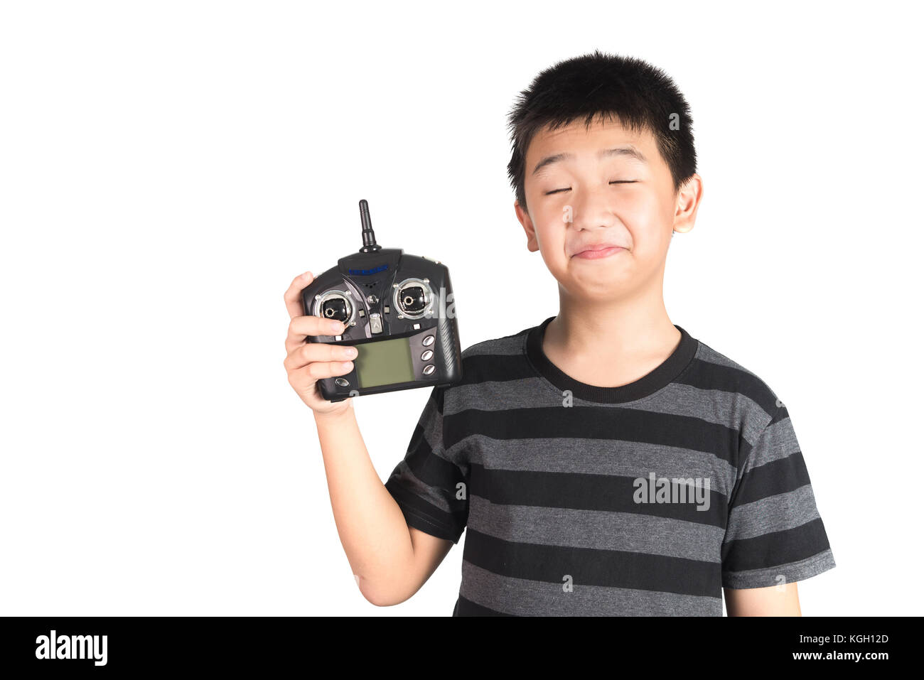 Asian boy holding radio remote control (controlling handset) for ...