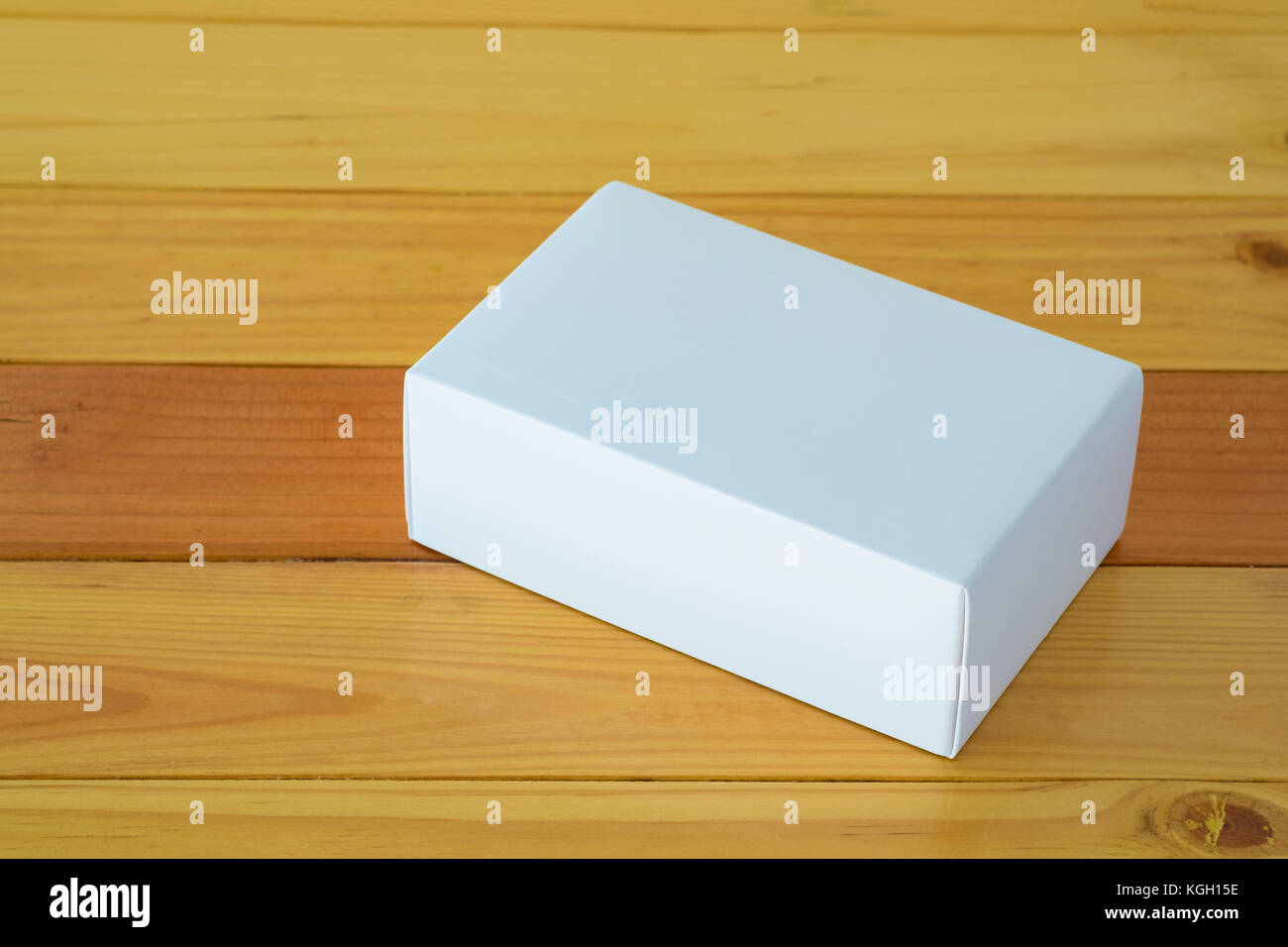 Empty white gift box for mock up on bright wooden table with copy space ...