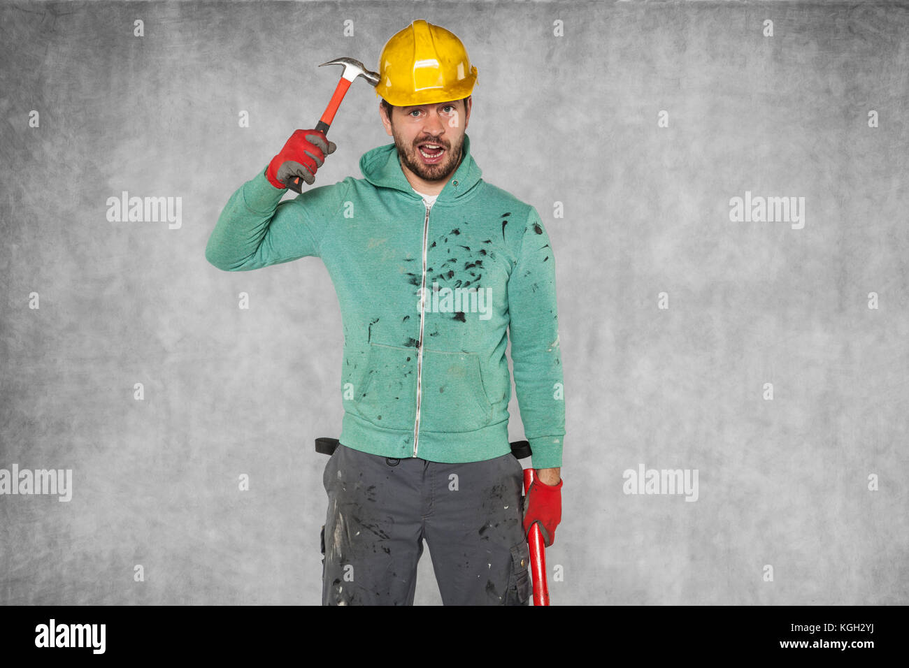 A mad worker hits a hammer on his head Stock Photo - Alamy