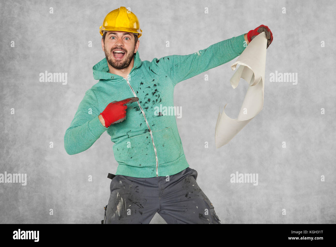 Pleasantly surprised worker indicates a construction plan Stock Photo ...