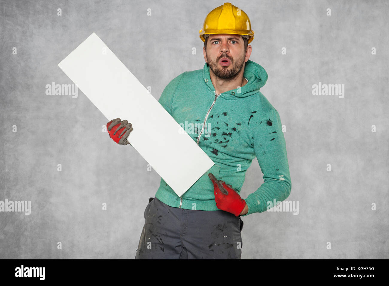 The worker in the helmet shows the place for the advertisement Stock ...