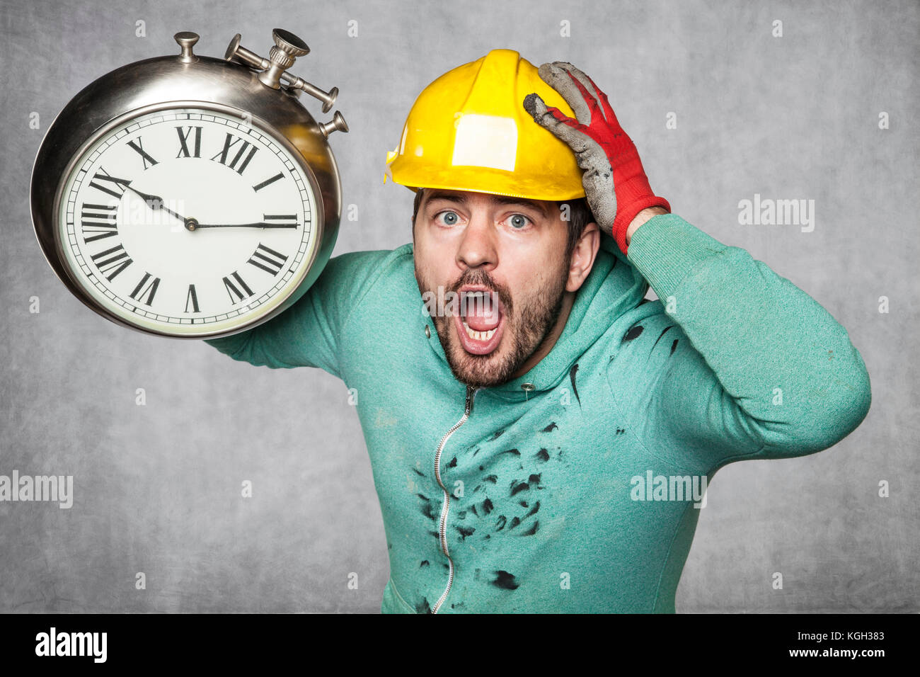 Construction worker holding clock hi-res stock photography and images ...