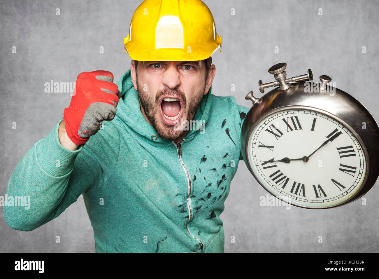 The worker shows furiously the clock Stock Photo - Alamy