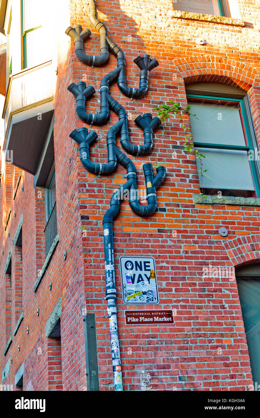 Complicated drain pipe decorates a red brick wall in Seattle ...