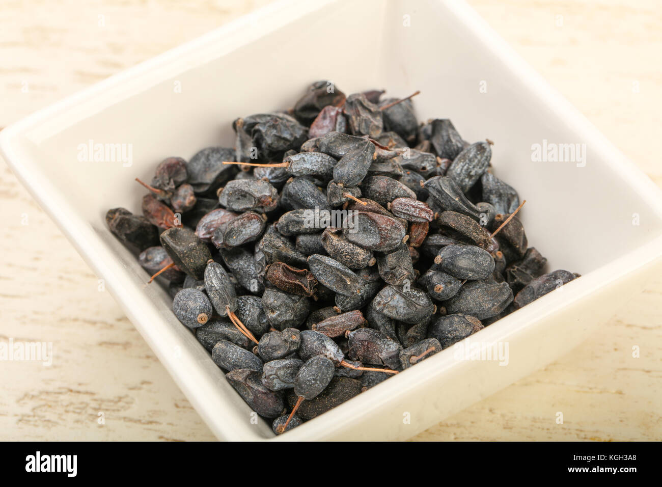 Dry barberry in the bowl over wooden background Stock Photo - Alamy