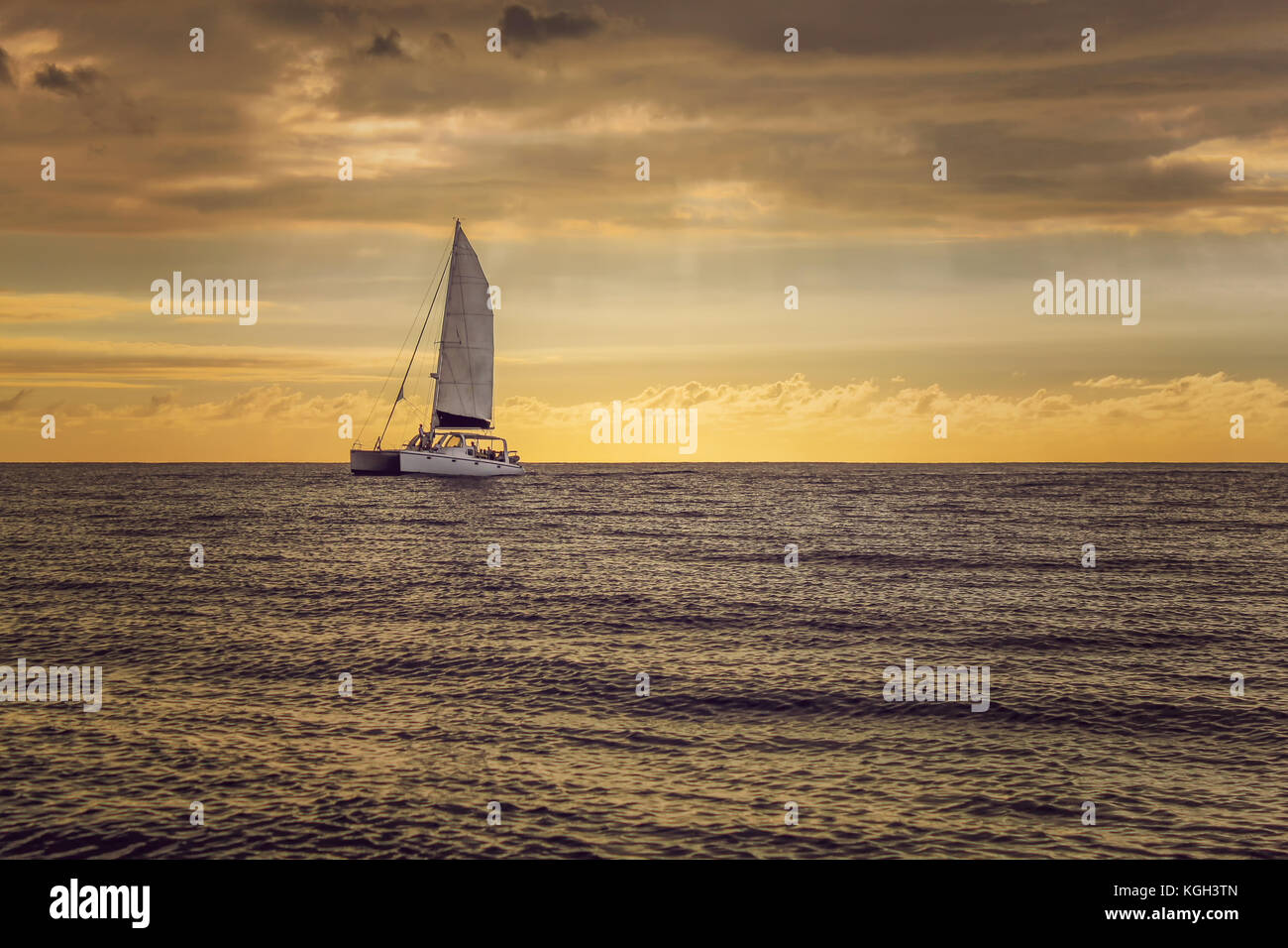 View on the yacht sailing on the ocean at the sunset Stock Photo - Alamy