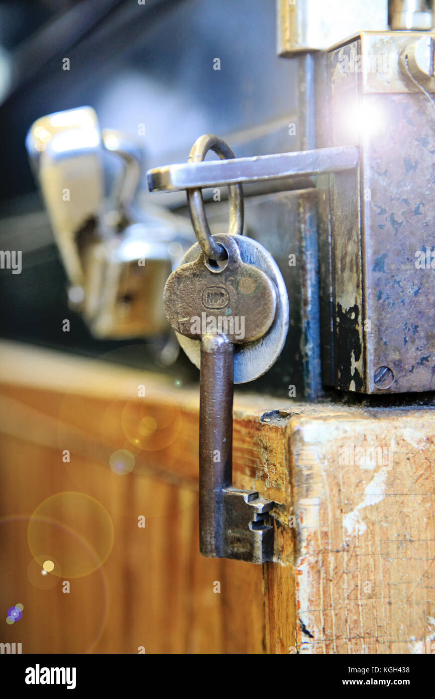 old style key hanging on a locker Stock Photo - Alamy