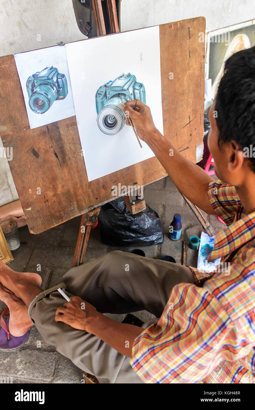 Man painting a dslr camera on a white canvas, streetart, Jakarta ...