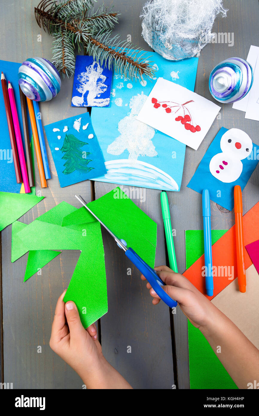 Child hands make handmade christmas toys from cardboard. Children's DIY ...