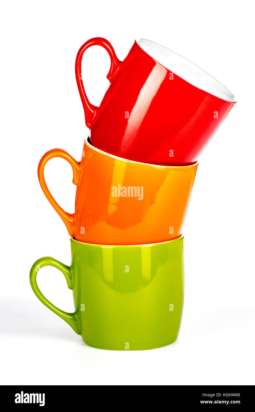 three stacked colored cups on a white background Stock Photo - Alamy