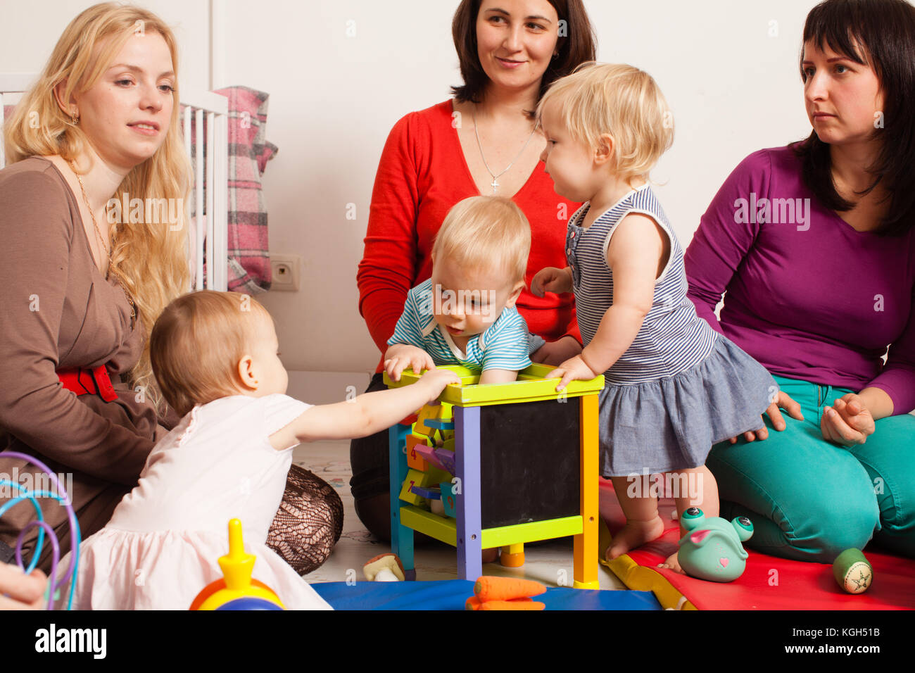 Group of mothers with their babies Stock Photo - Alamy