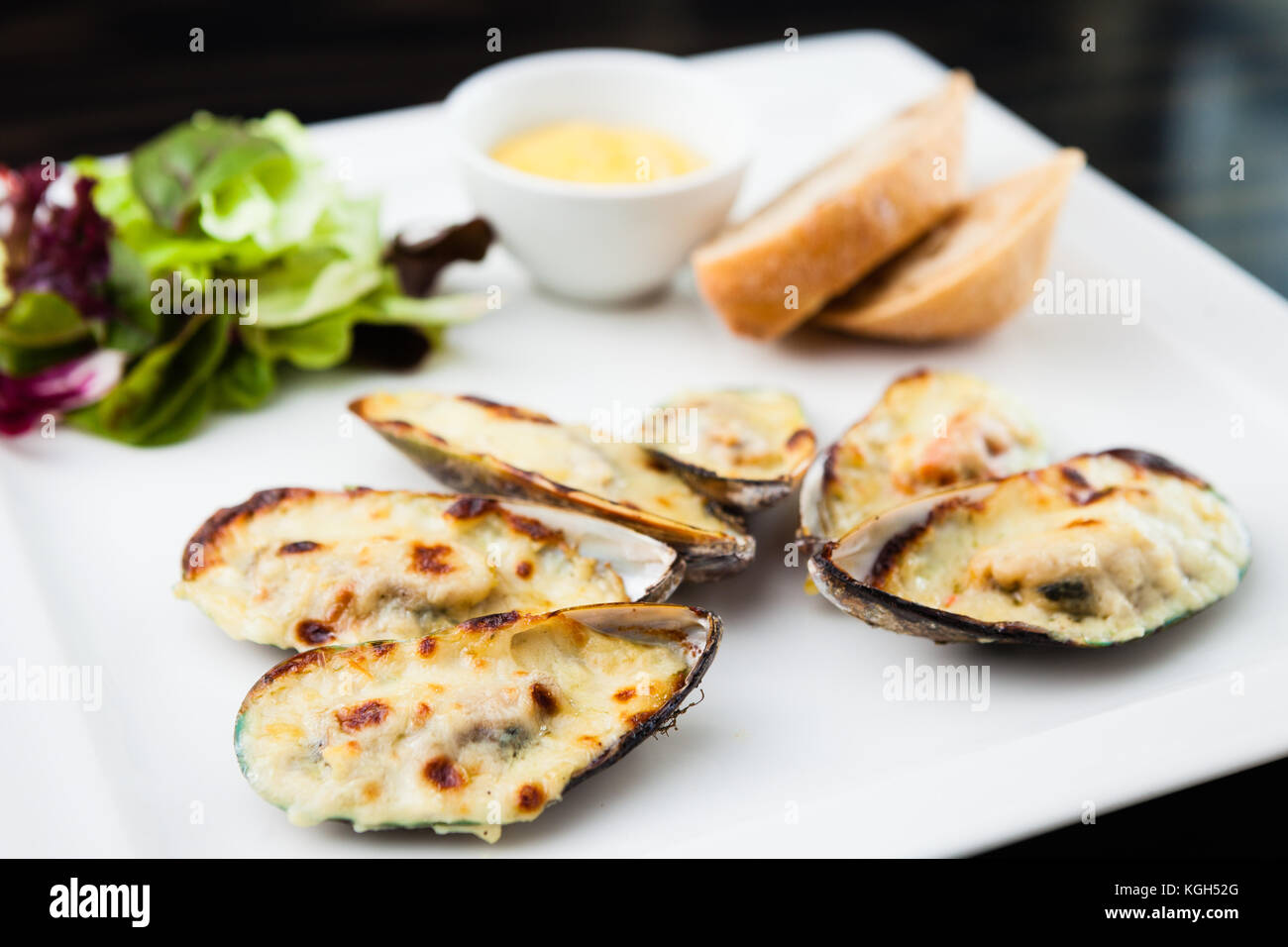 Baked mussels au gratin Stock Photo - Alamy