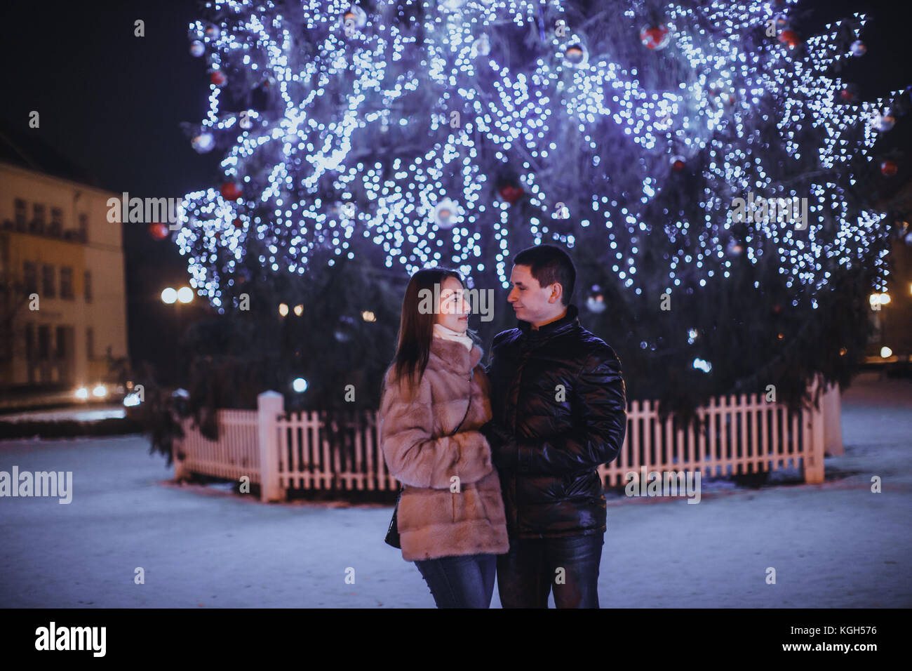 Couple and The Christmas tree Stock Photo - Alamy