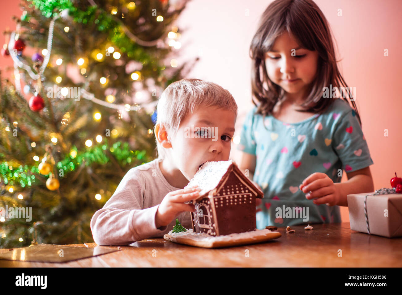Little boy with gingerbread house Stock Photo - Alamy
