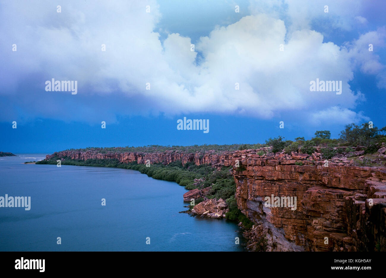 Sandstone escarpment meets the coast, with tropical cyclone clouds ...