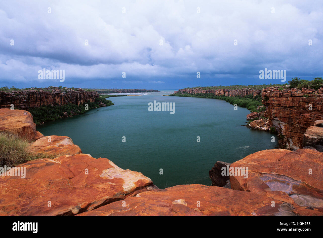 Sandstone escarpment meets the coast with tropical cyclone clouds ...