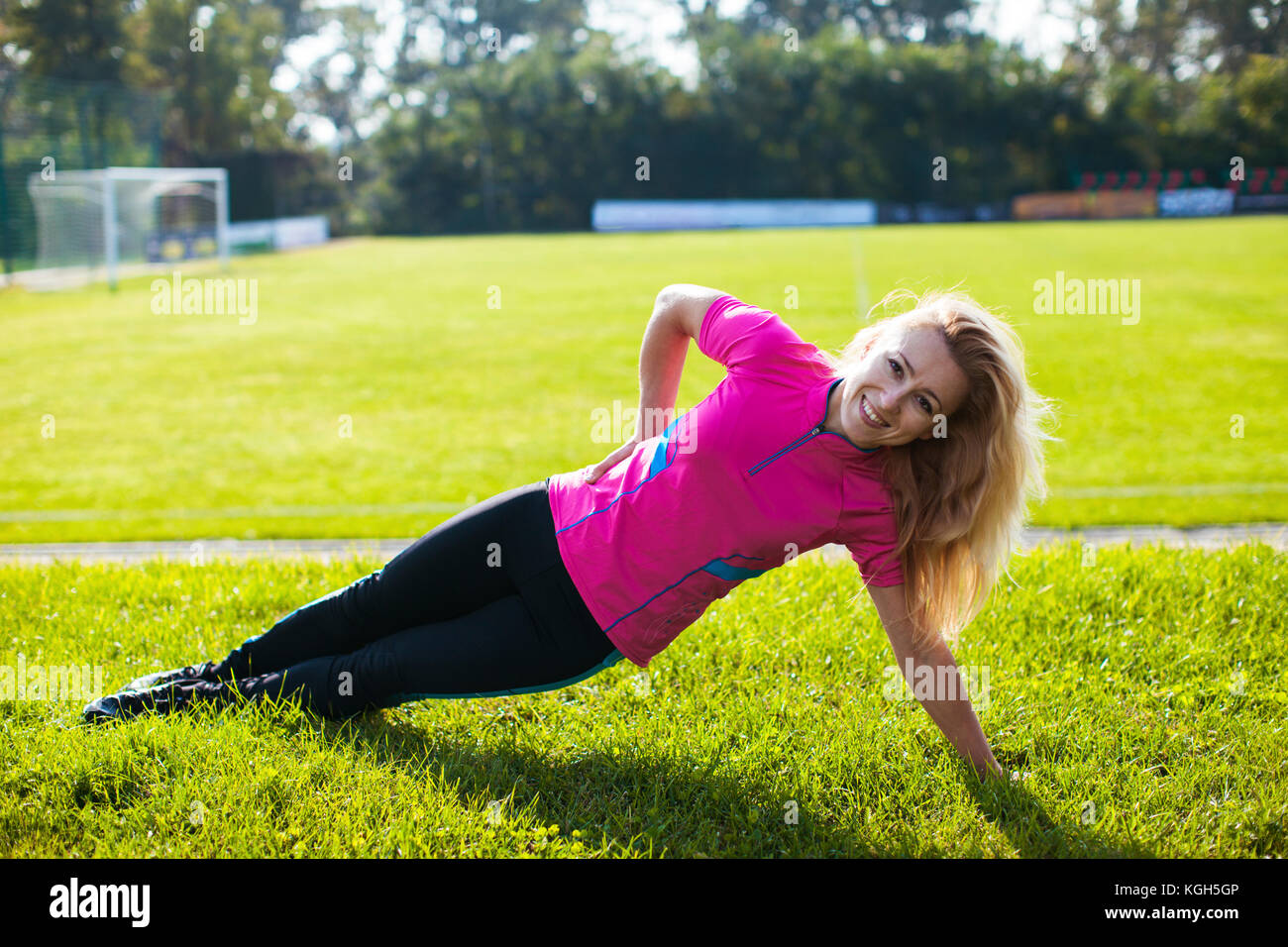 Two women doing stretching exercise Stock Photo - Alamy
