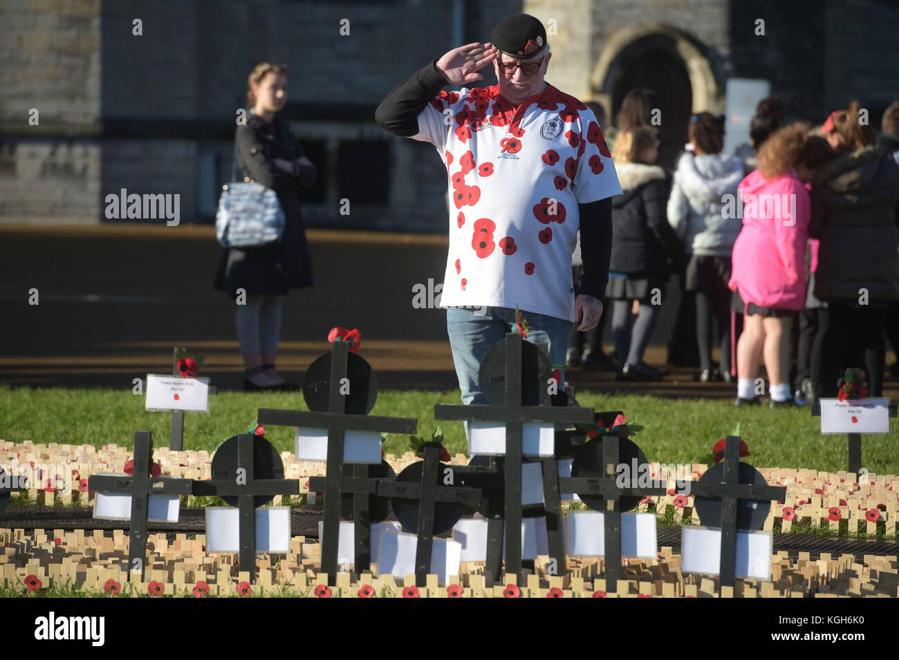 A man salutes as he looks at tributes in the Field of Remembrance at ...