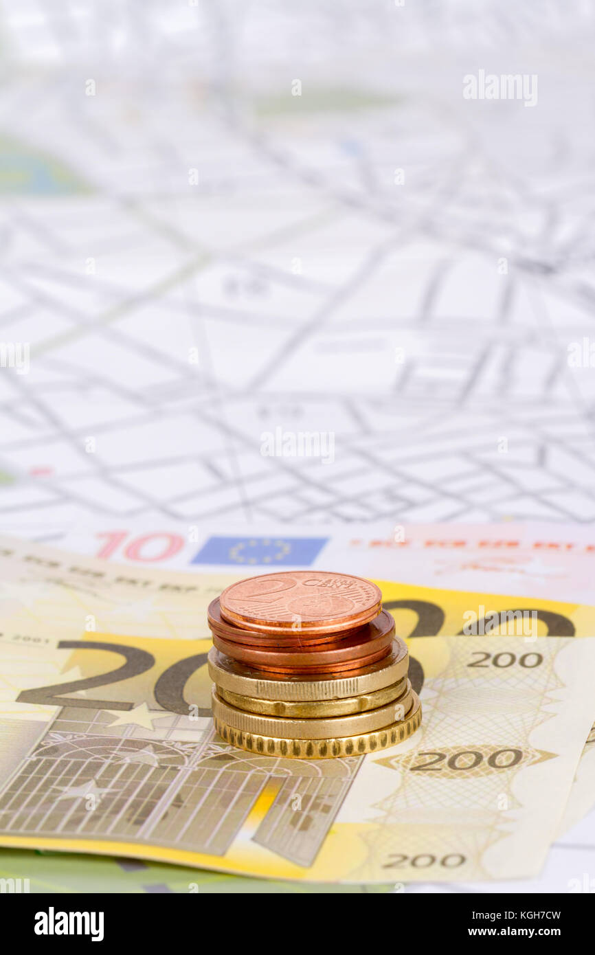 Euro coins and banknotes with city map background in touristic travel ...