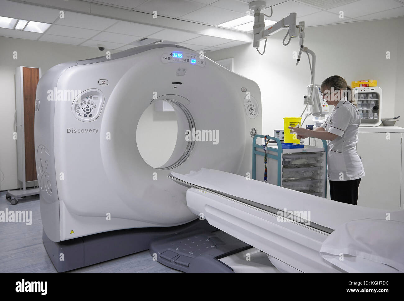 A radiographer preparing a MRI scanning machine for a patient in a ...