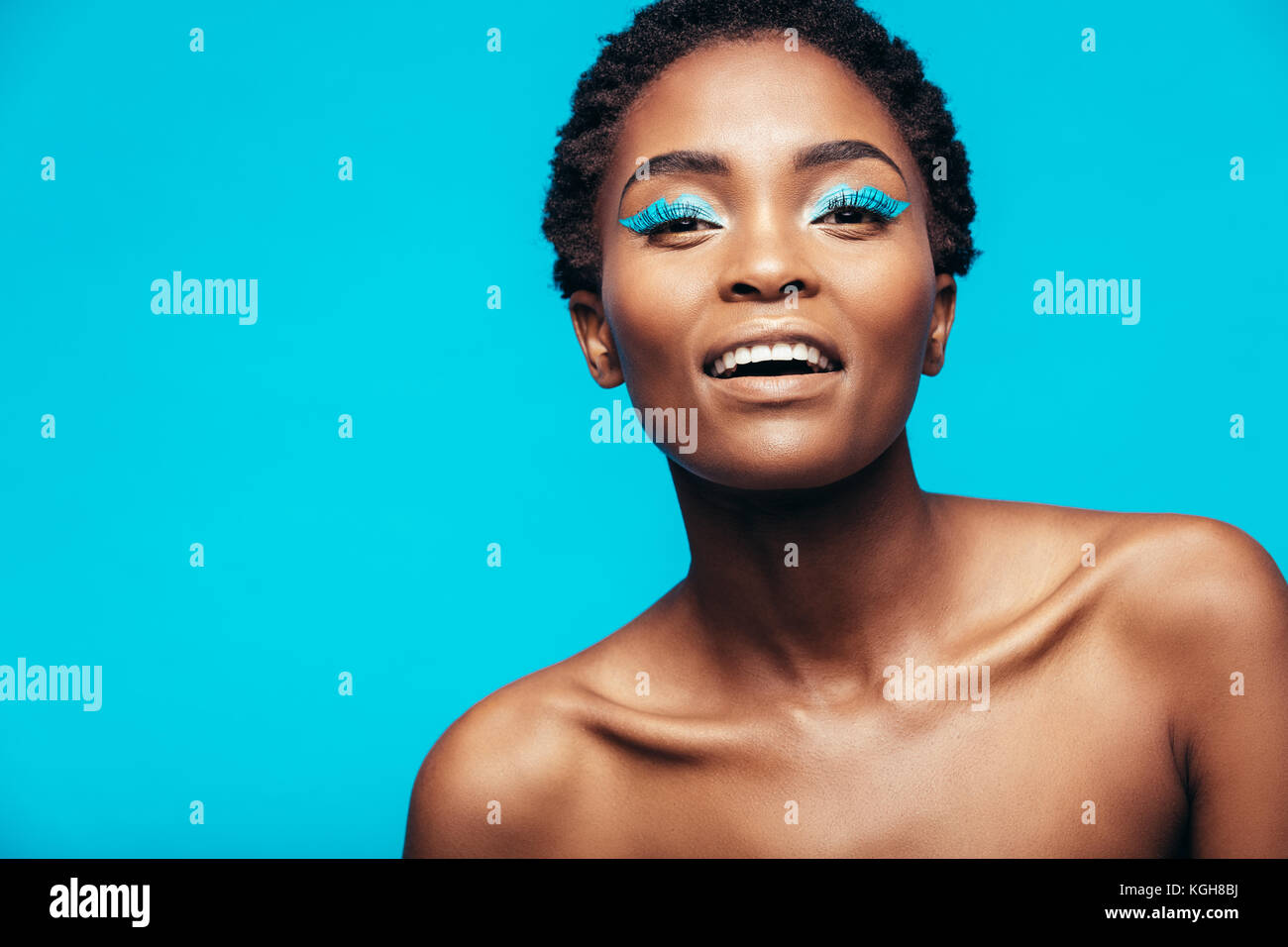 Close up of african woman with blue eye shadow makeup. Beauty portrait ...