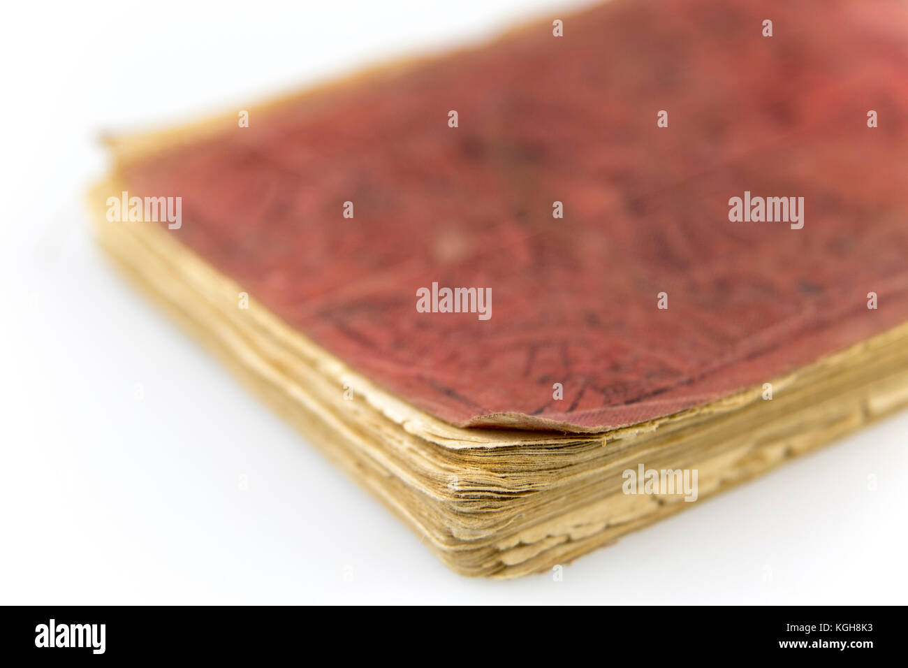 Old antique worn book with worn bent page edges and red stained cover ...