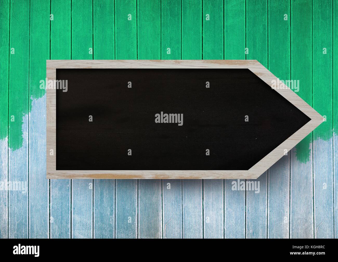 Digital composite of Blackboard arrow sign on wood Stock Photo - Alamy