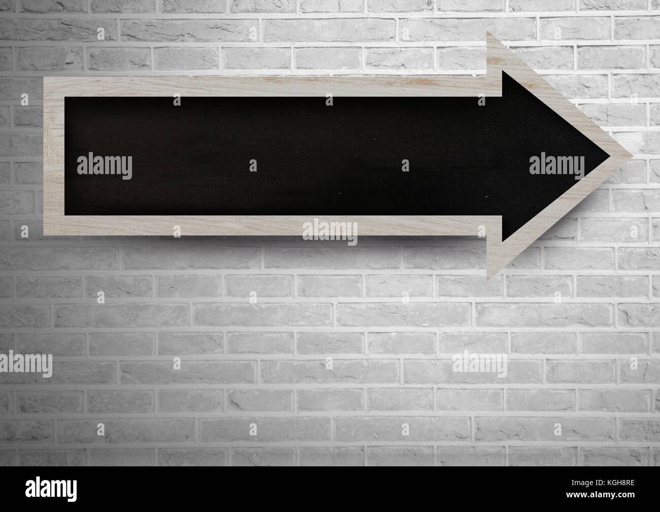 Digital composite of Blackboard arrow sign on wall Stock Photo - Alamy