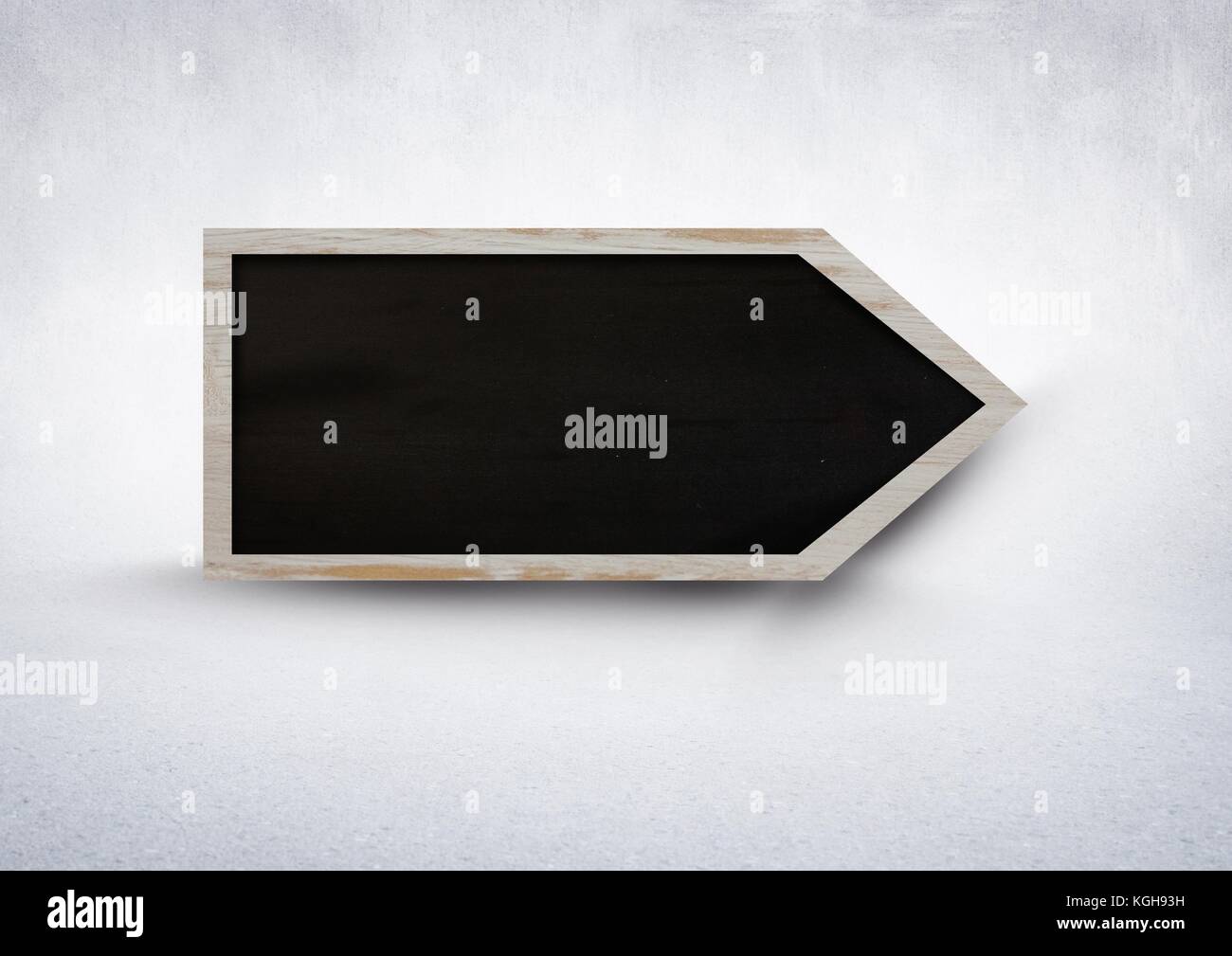 Digital composite of Blackboard arrow sign on wall Stock Photo - Alamy