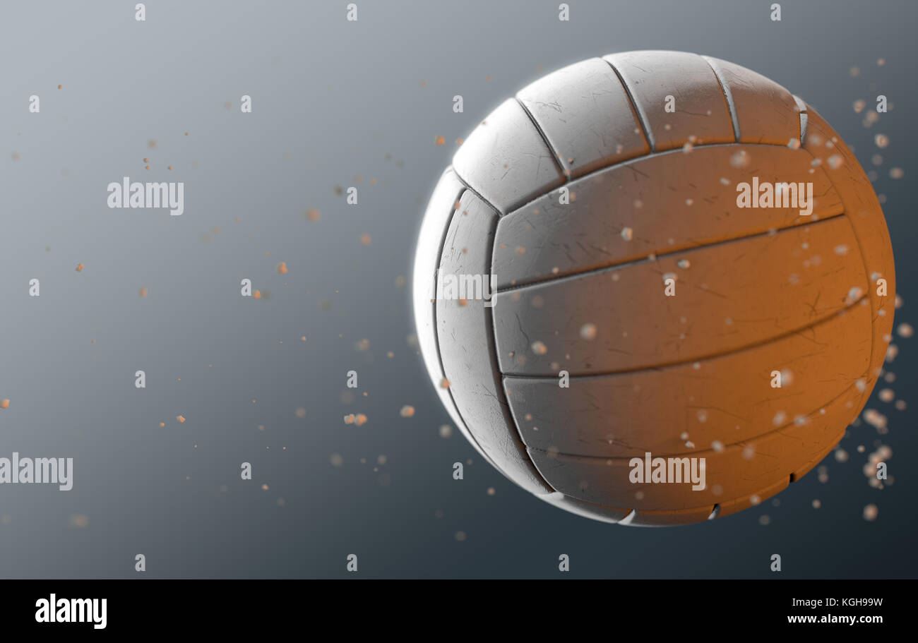A dirty white volleyball caught in slow motion flying through the air ...
