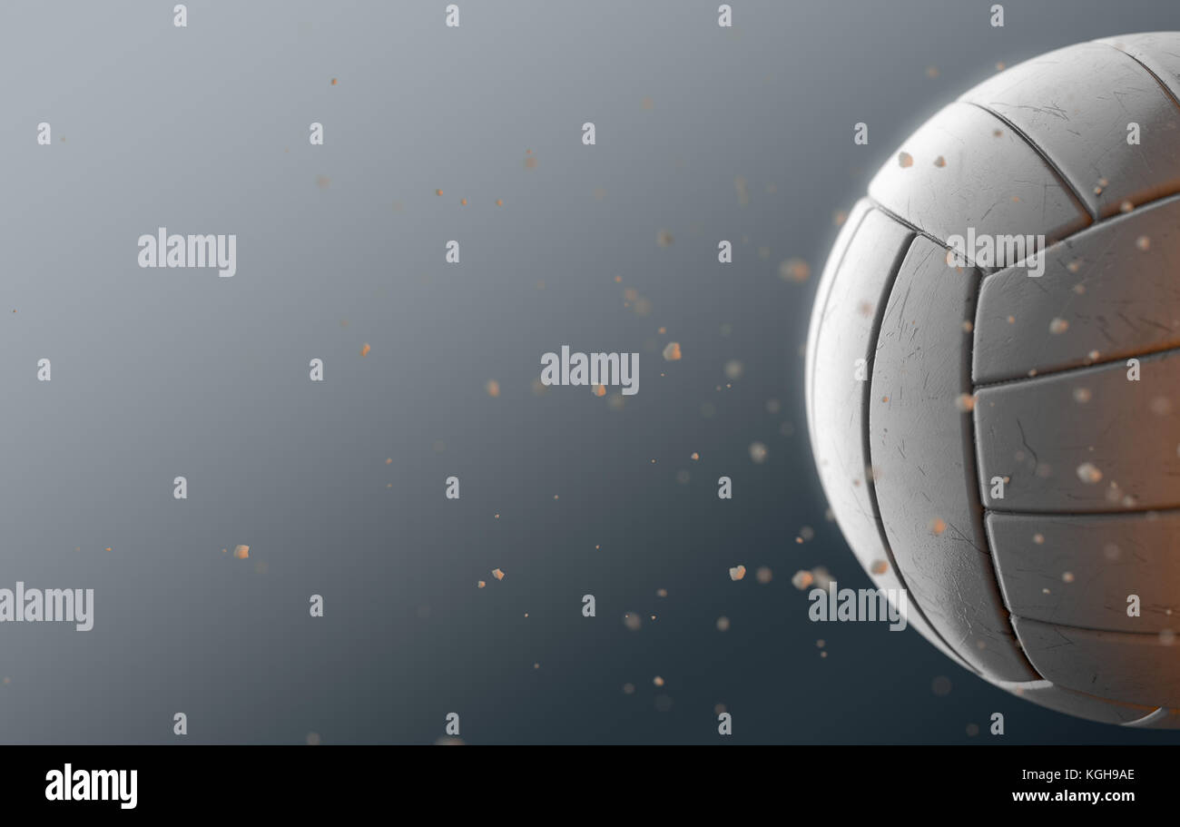 A dirty white volleyball caught in slow motion flying through the air ...