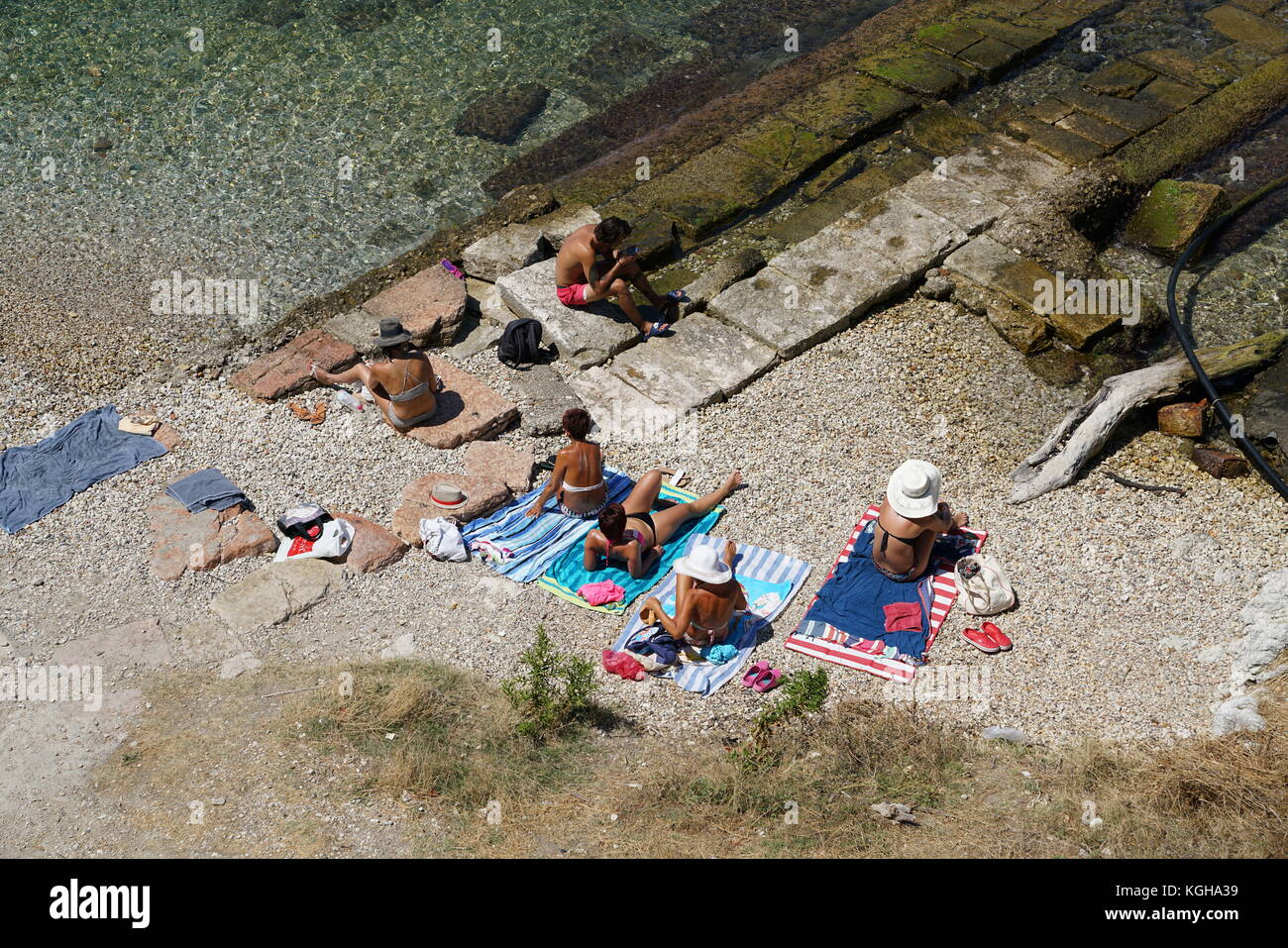 Corfu, Greece: People at the beach swimming and sunbathing Stock Photo ...