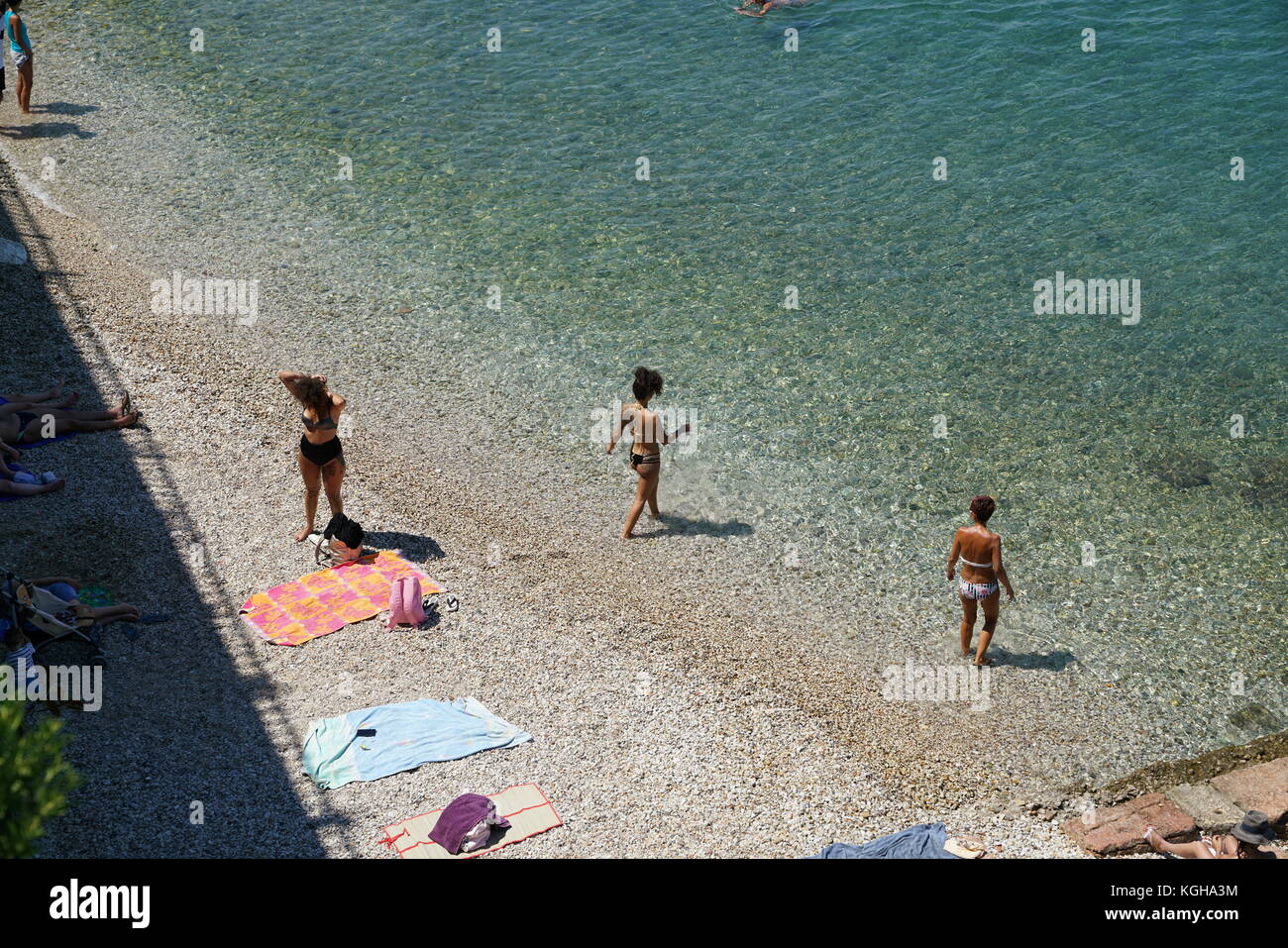 Corfu, Greece: People at the beach swimming and sunbathing Stock Photo ...