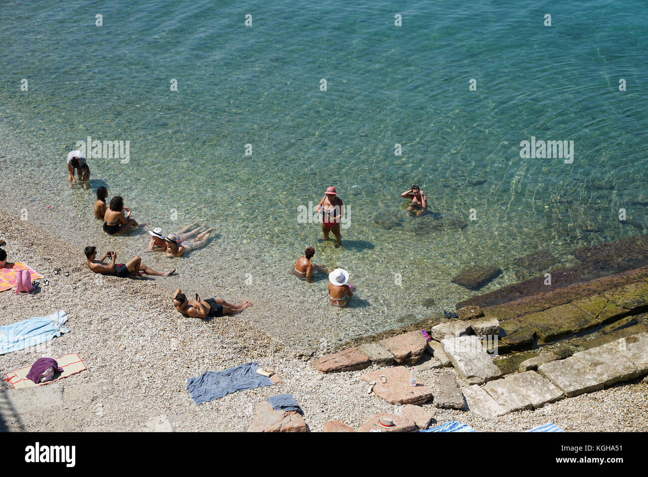 Corfu, Greece: People at the beach swimming and sunbathing Stock Photo ...