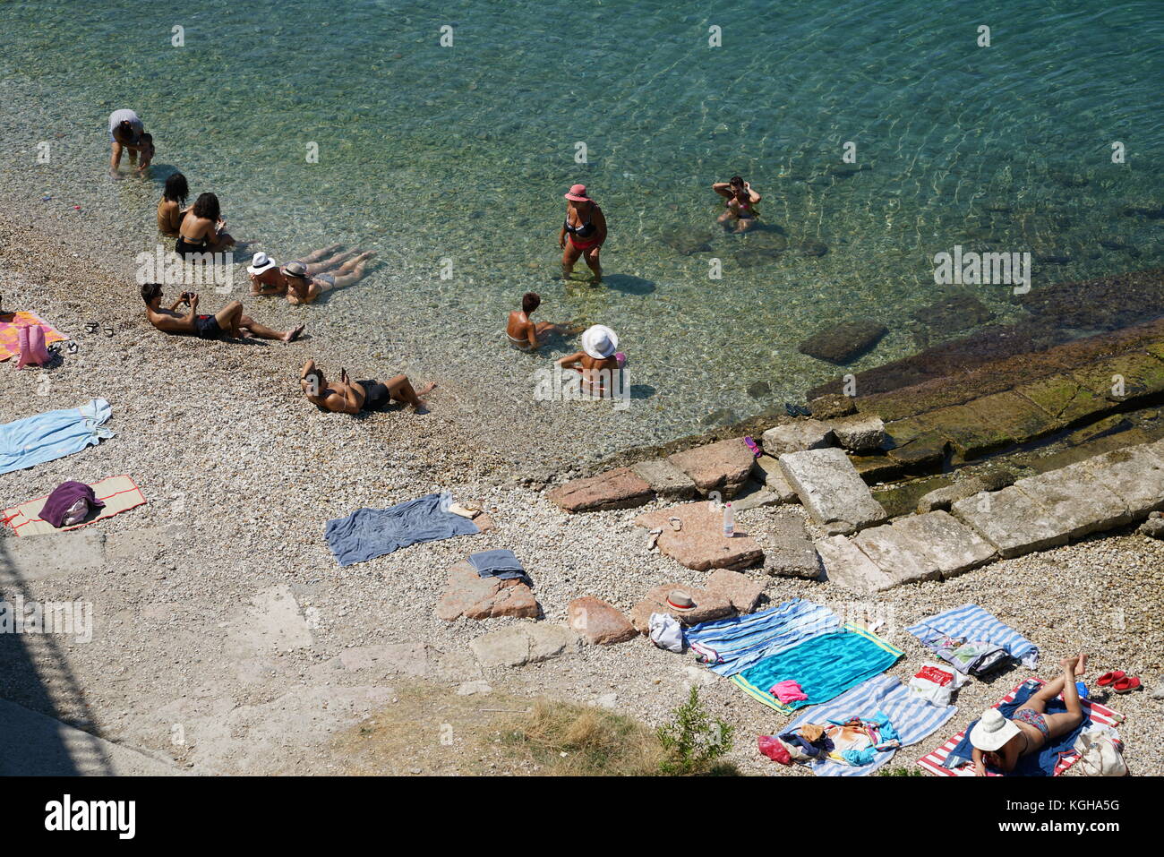 Corfu, Greece: People at the beach swimming and sunbathing Stock Photo ...