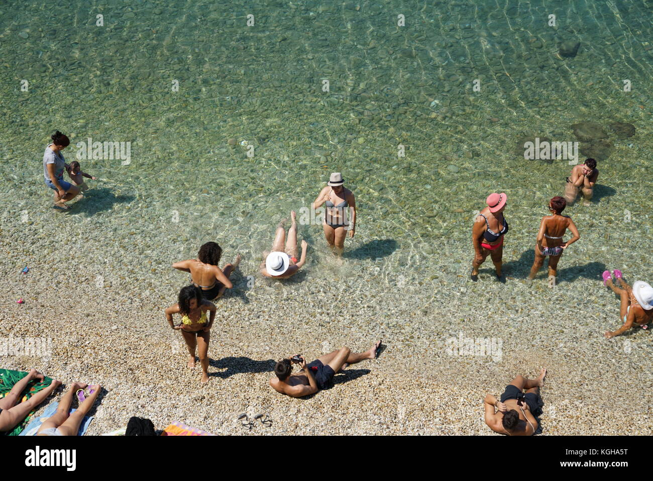 Corfu, Greece: People at the beach swimming and sunbathing Stock Photo ...
