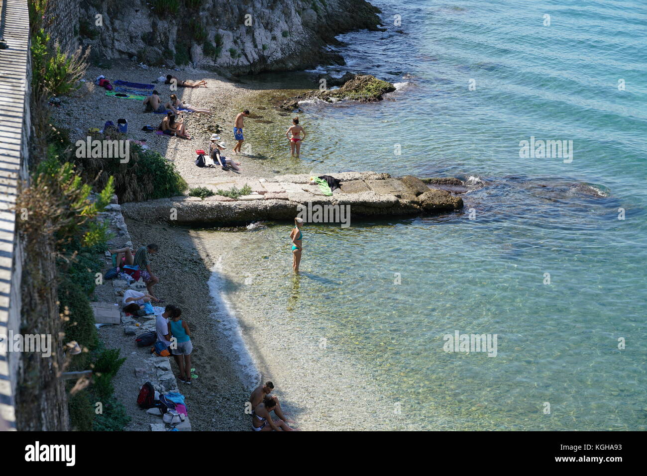 Corfu, Greece: People at the beach swimming and sunbathing Stock Photo ...