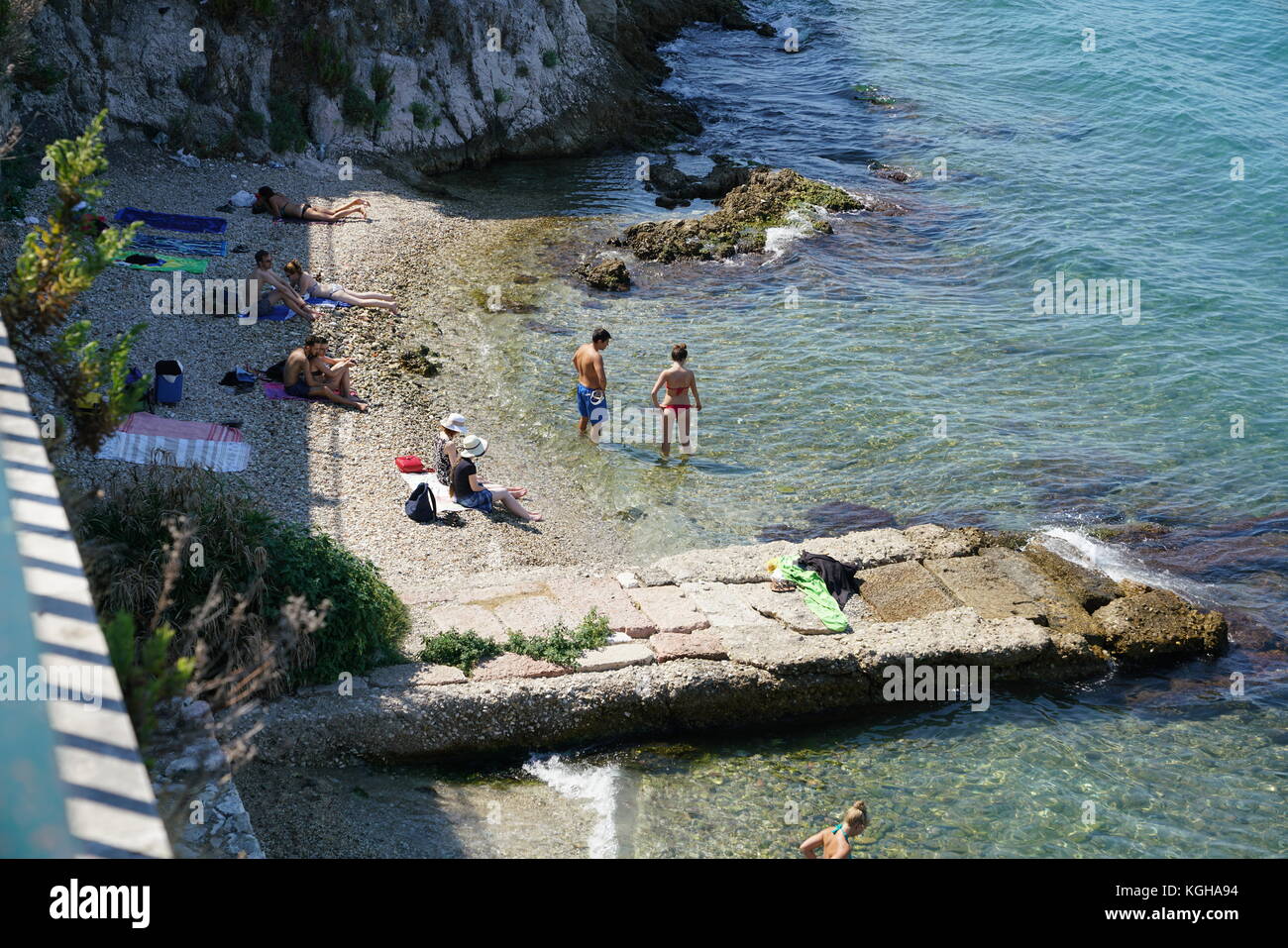 Corfu, Greece: People at the beach swimming and sunbathing Stock Photo ...
