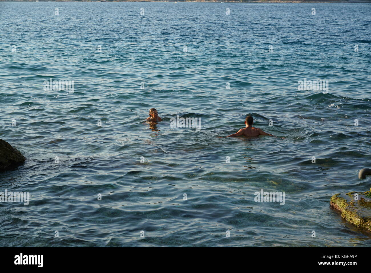 Corfu, Greece: People at the beach swimming and sunbathing Stock Photo ...