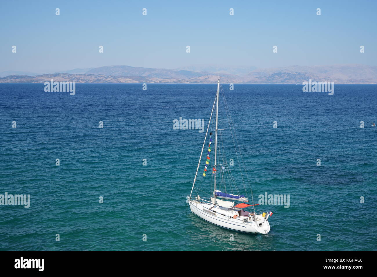 Corfu, Greece: White sailboat in the sea of Notio Steno Kerkiras Stock ...