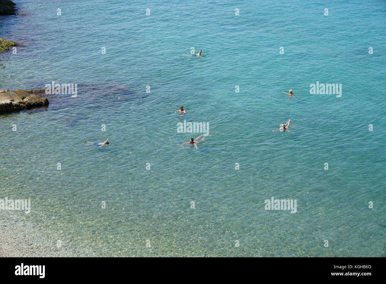 Corfu, Greece: People swimming in the sea at the beach of Kerkyra Old ...