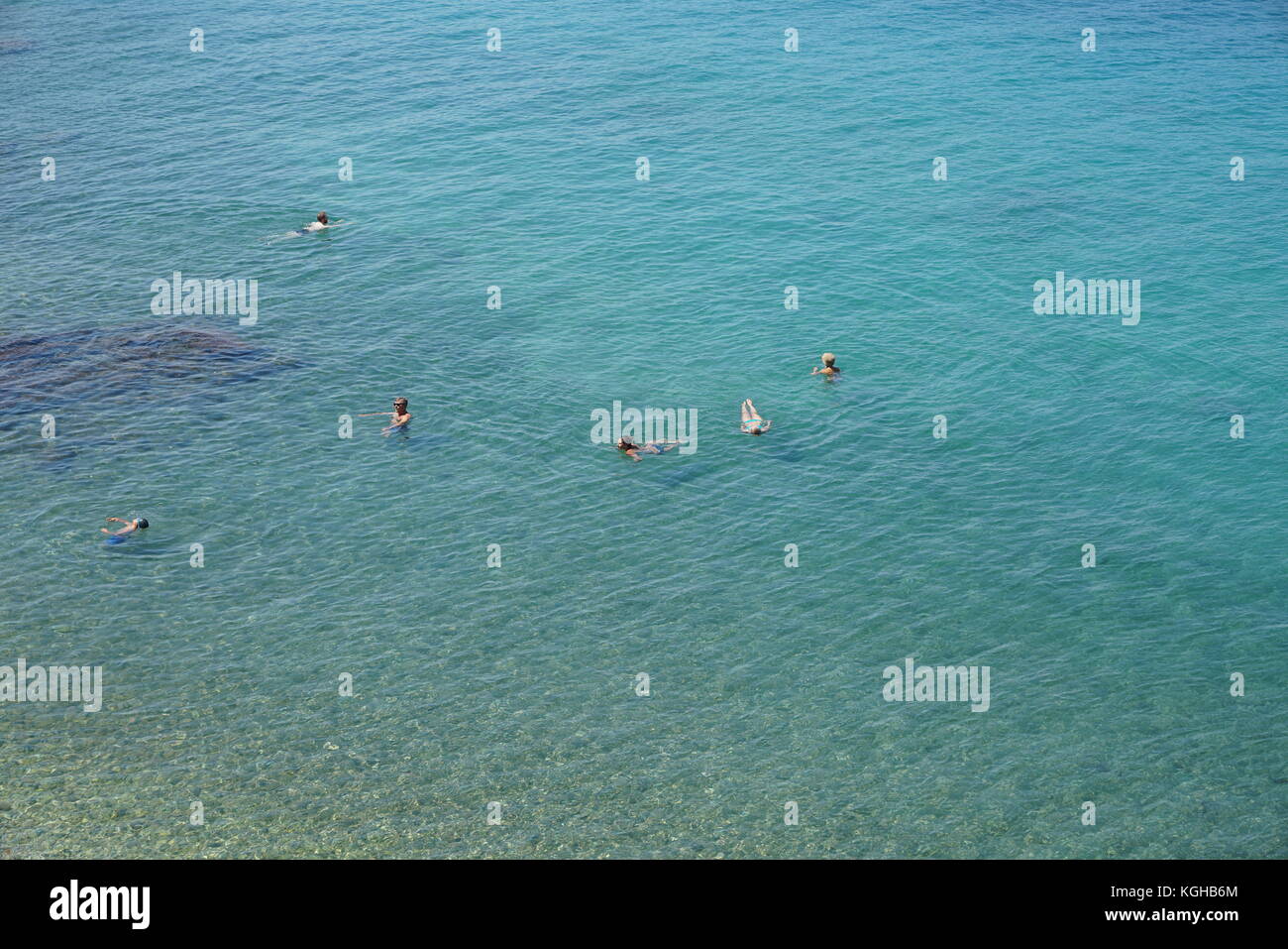 Corfu, Greece: People swimming in the sea at the beach of Kerkyra Old ...